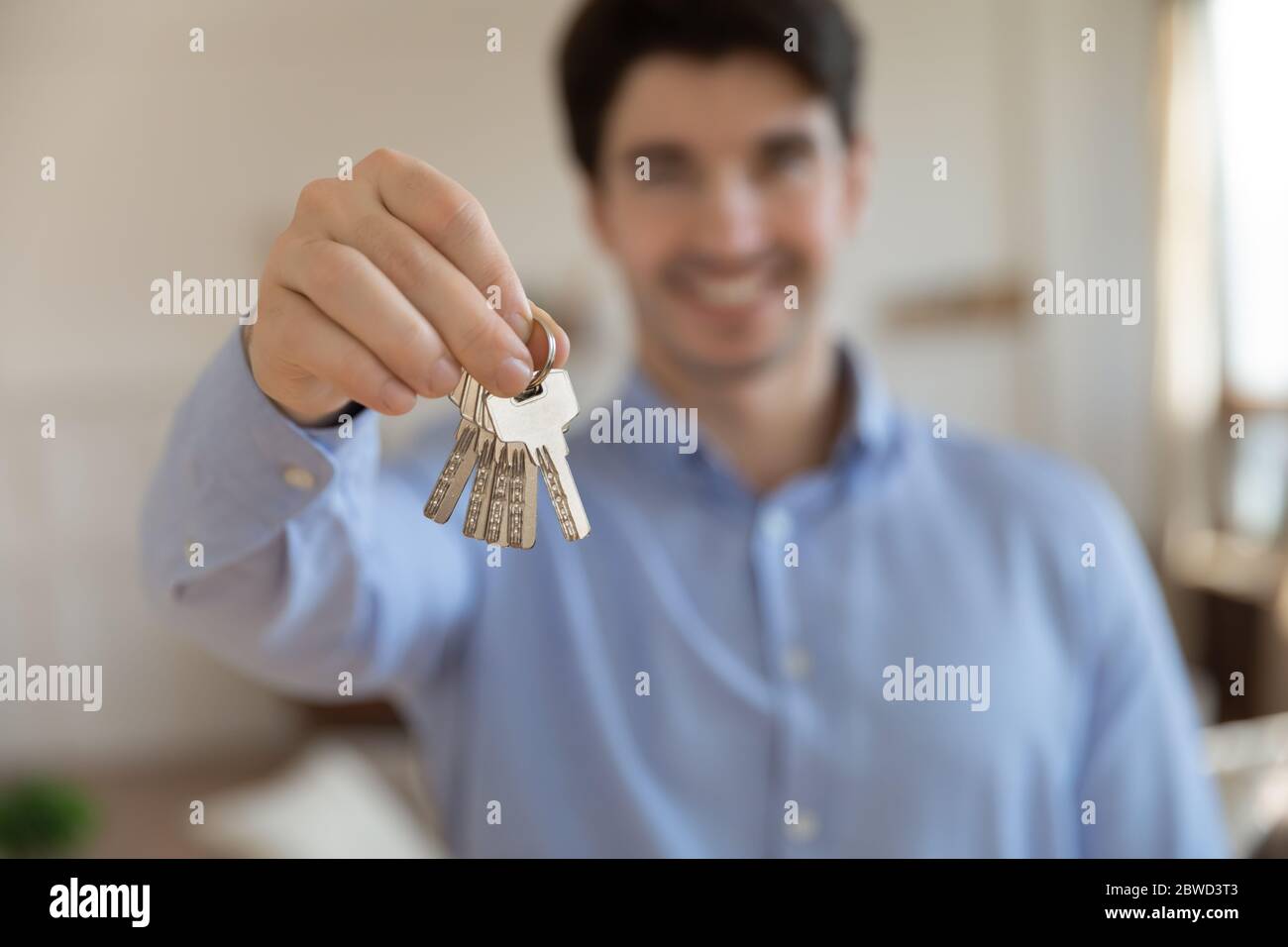 Close up of happy young male renter show house keys Stock Photo - Alamy