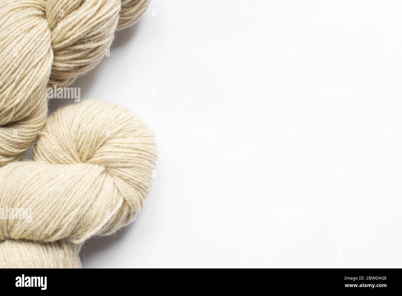 beige yarn on white background with copy space Stock Photo - Alamy