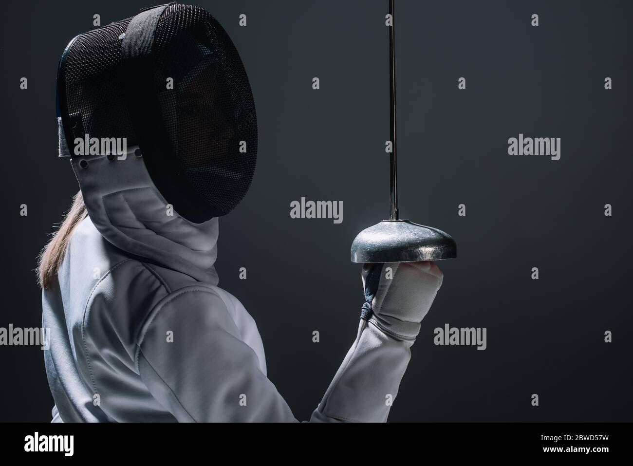 Back view of fencer holding rapier isolated on black Stock Photo - Alamy