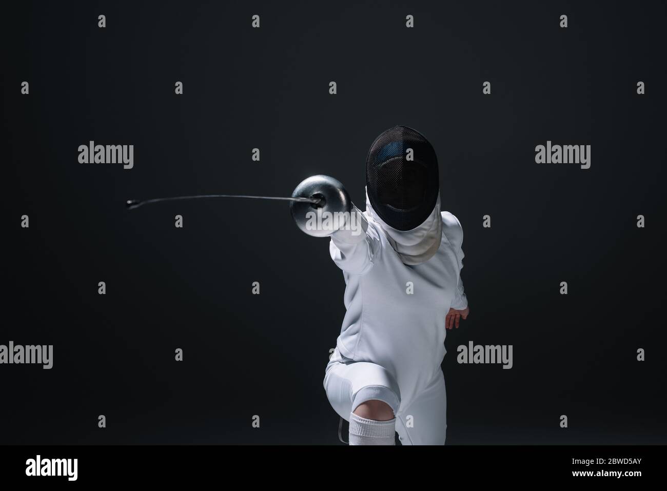 Fencer holding rapier while training isolated on black Stock Photo - Alamy