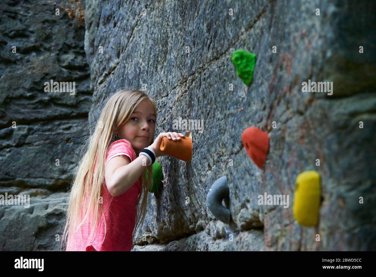 Girl having fun during rock climbing training on boulder wall Stock ...