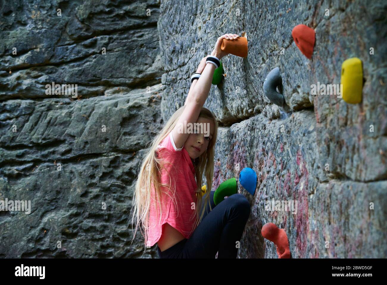 Girl having fun during rock climbing training on boulder wall Stock ...