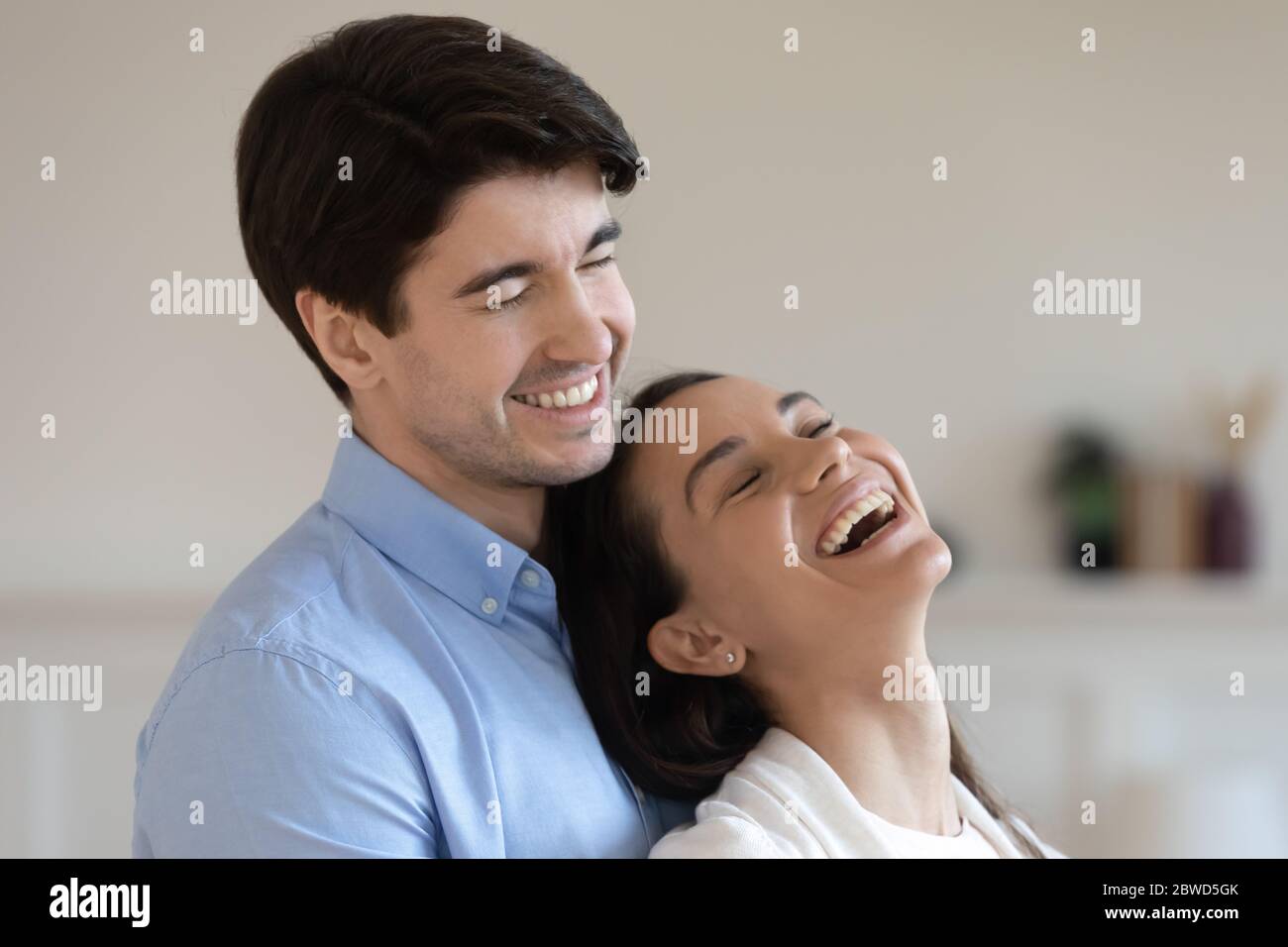 Overjoyed young couple hug enjoy time together Stock Photo - Alamy