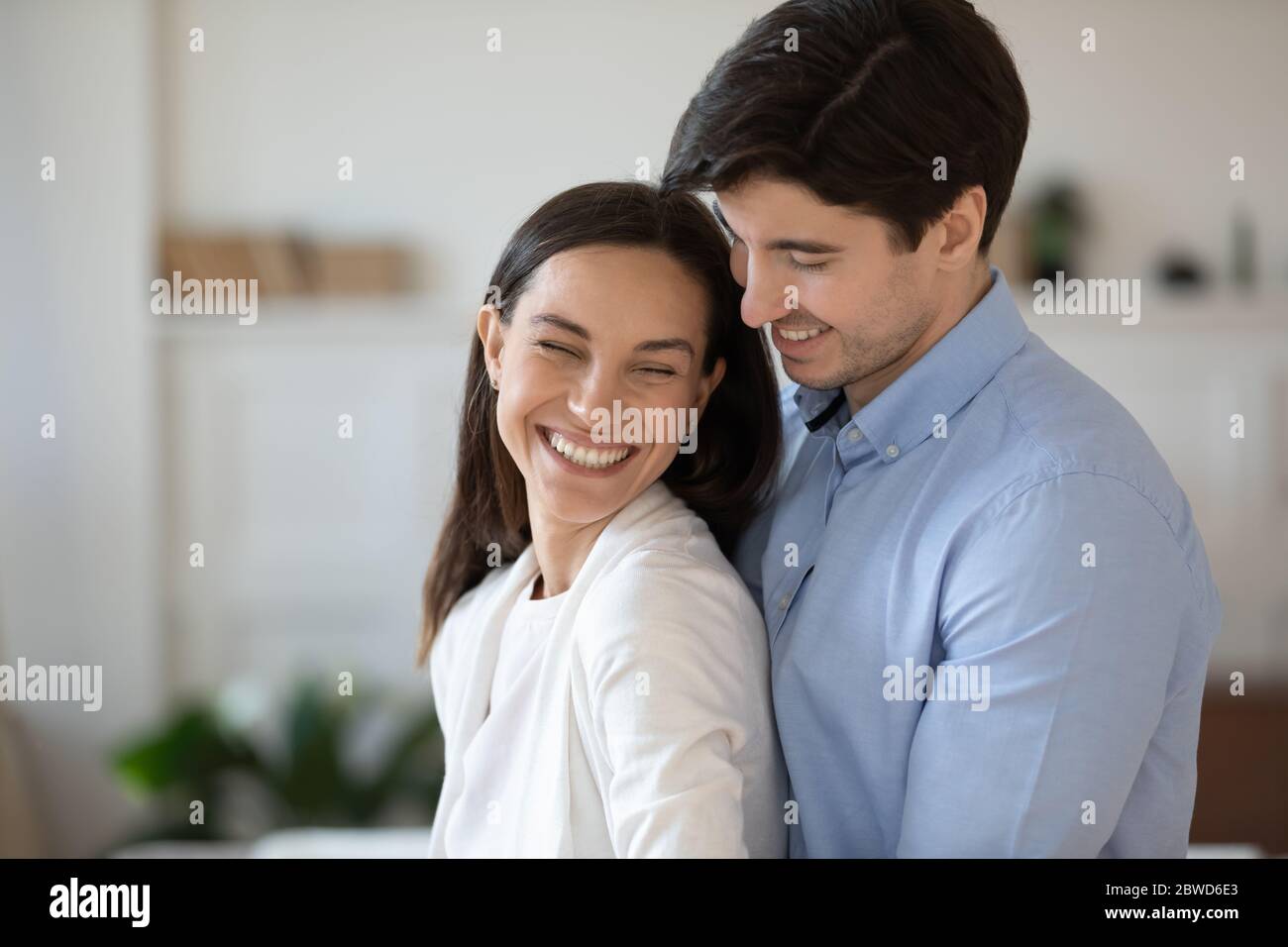 Overjoyed young couple hug showing care and affection Stock Photo - Alamy