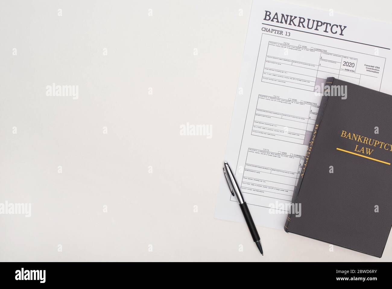 top view of bankruptcy paper, pen and law book on white background ...