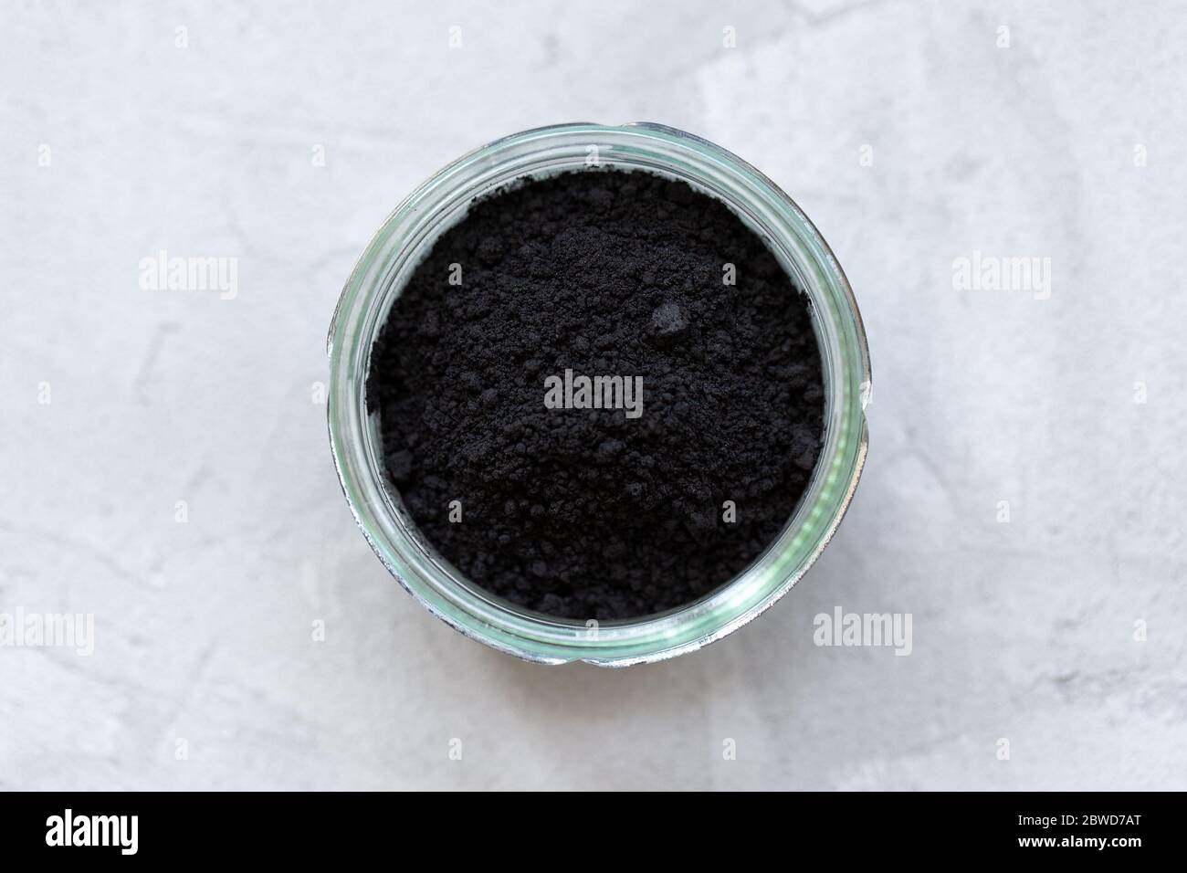 Black activated charcoal powder in a glass Stock Photo - Alamy