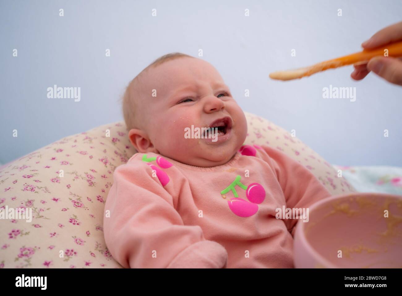 Little baby girl does not want to eat food. Cute baby girl makes angry ...