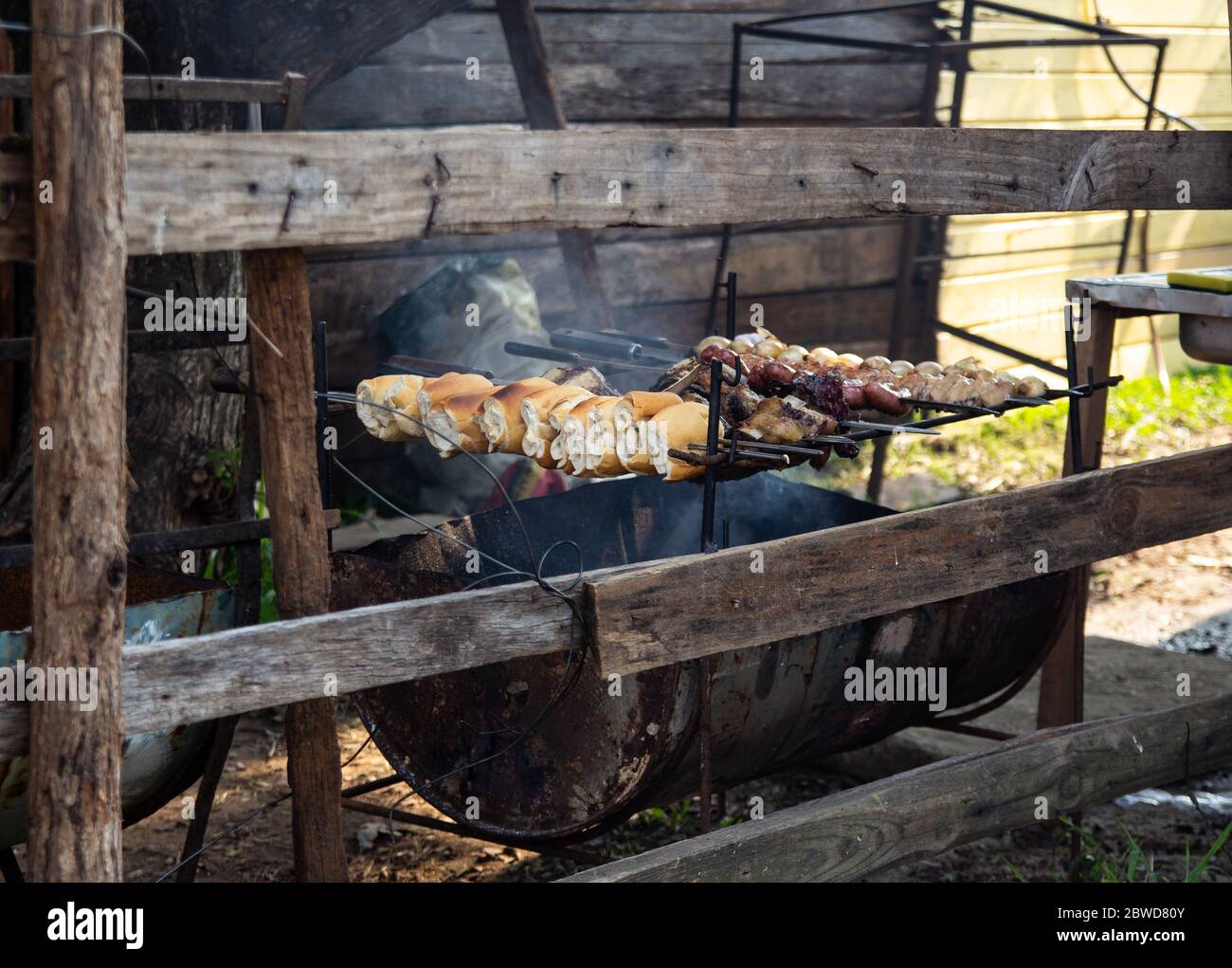 Rustic barbecue in rural area being prepared in the backyard ...