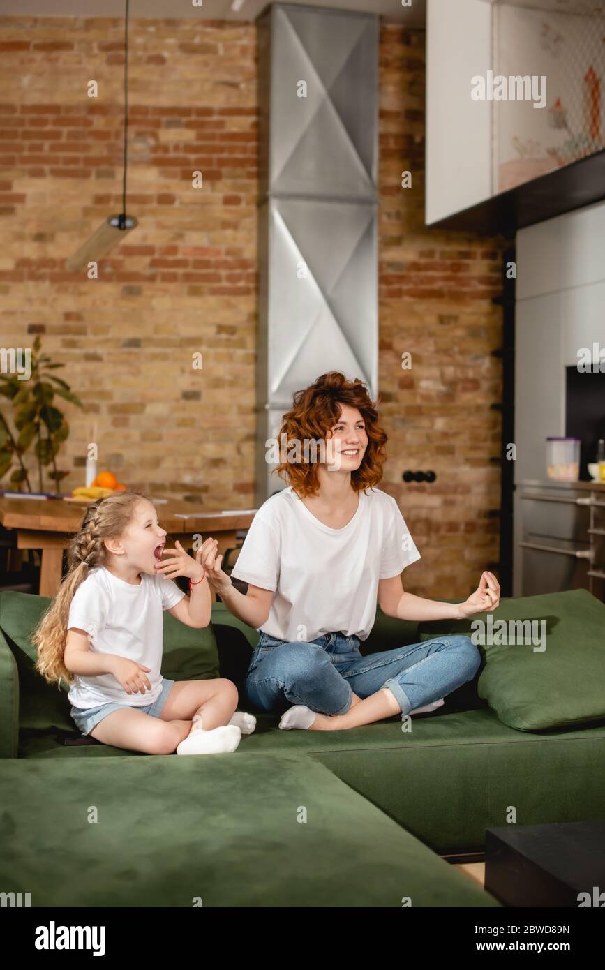 Attractive mother practice yoga hi-res stock photography and images - Alamy