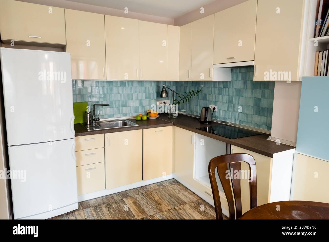 modern fridge near sink and faucet in modern kitchen Stock Photo - Alamy