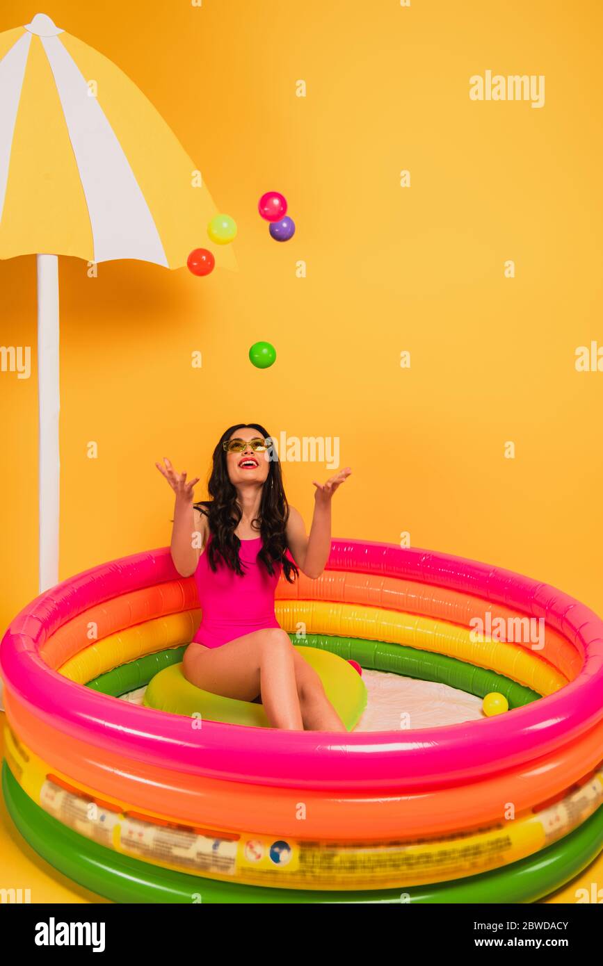 Girl in pink swimsuit sitting hi-res stock photography and images - Alamy