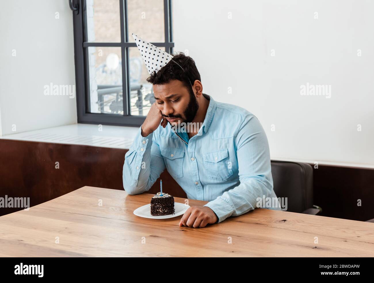 sad african american man in party cap celebrating birthday alone and ...