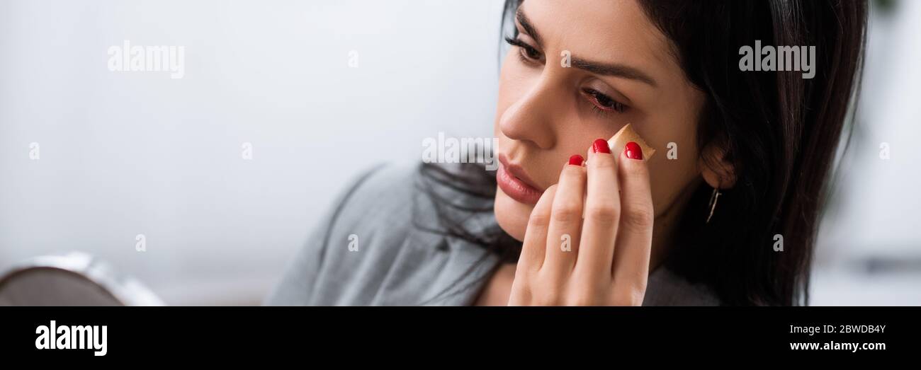 panoramic orientation of businesswoman with bruise on face applying ...