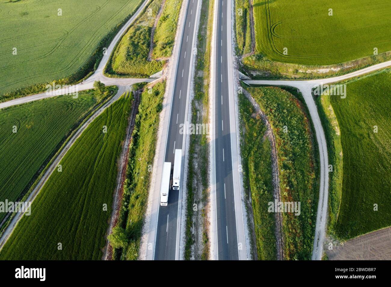 Aerial view of a highway with cars and trucks, in a beautiful ...