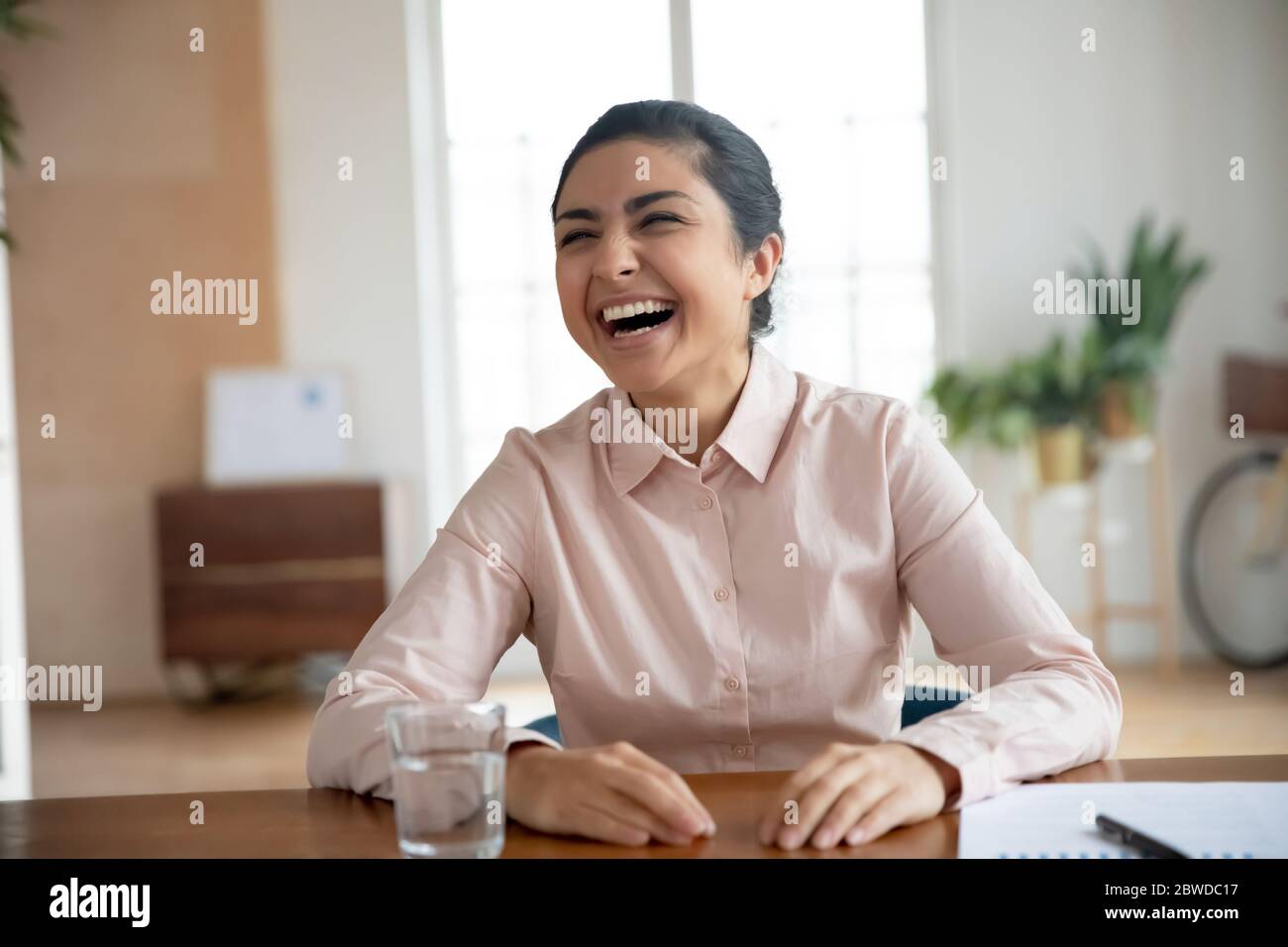 Overjoyed young indian woman having fun on job interview Stock Photo ...