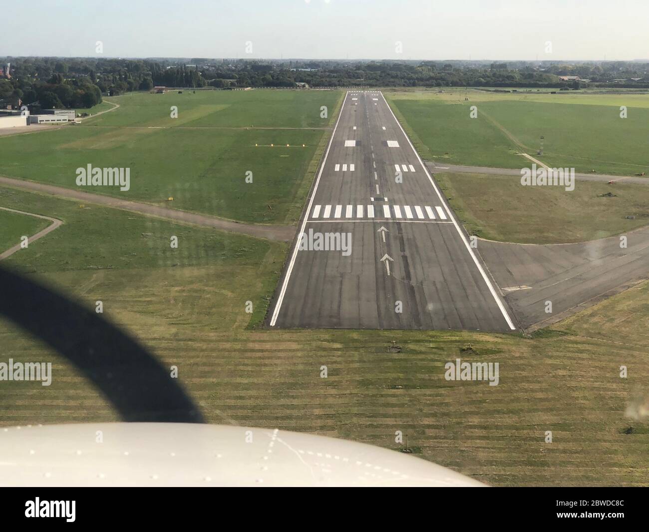Approaching a runway strip with a propeller plane Stock Photo - Alamy