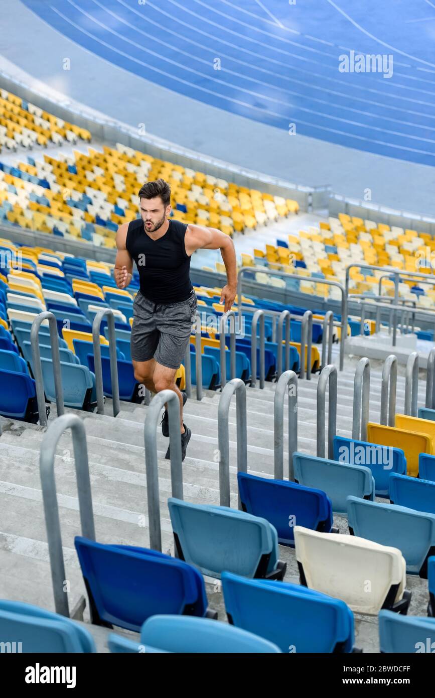 young sportsman running on stairs at stadium Stock Photo - Alamy