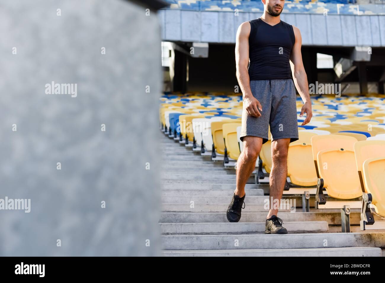 cropped view of young sportsman walking on stairs at stadium Stock ...