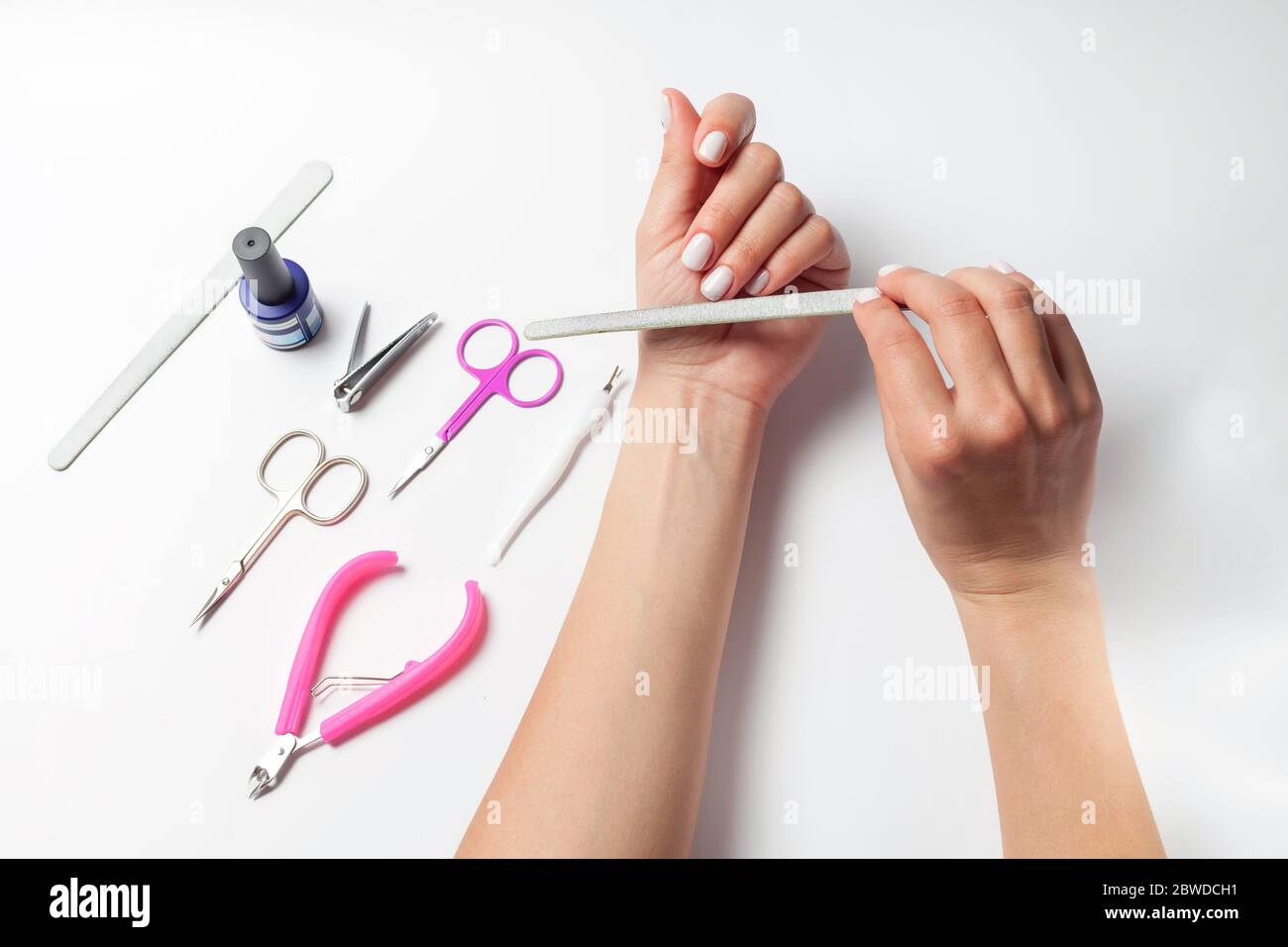 Female hands hold a nail file, next to lay down devices for nail care ...