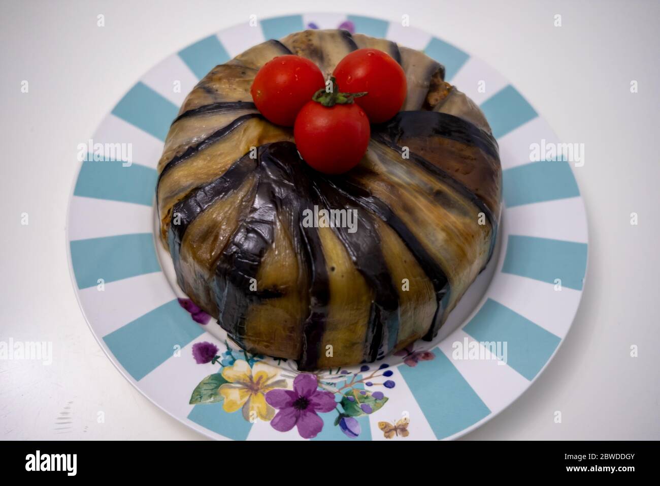 Top view of turkish food with eggplant, tomato and minced meat,ready to ...