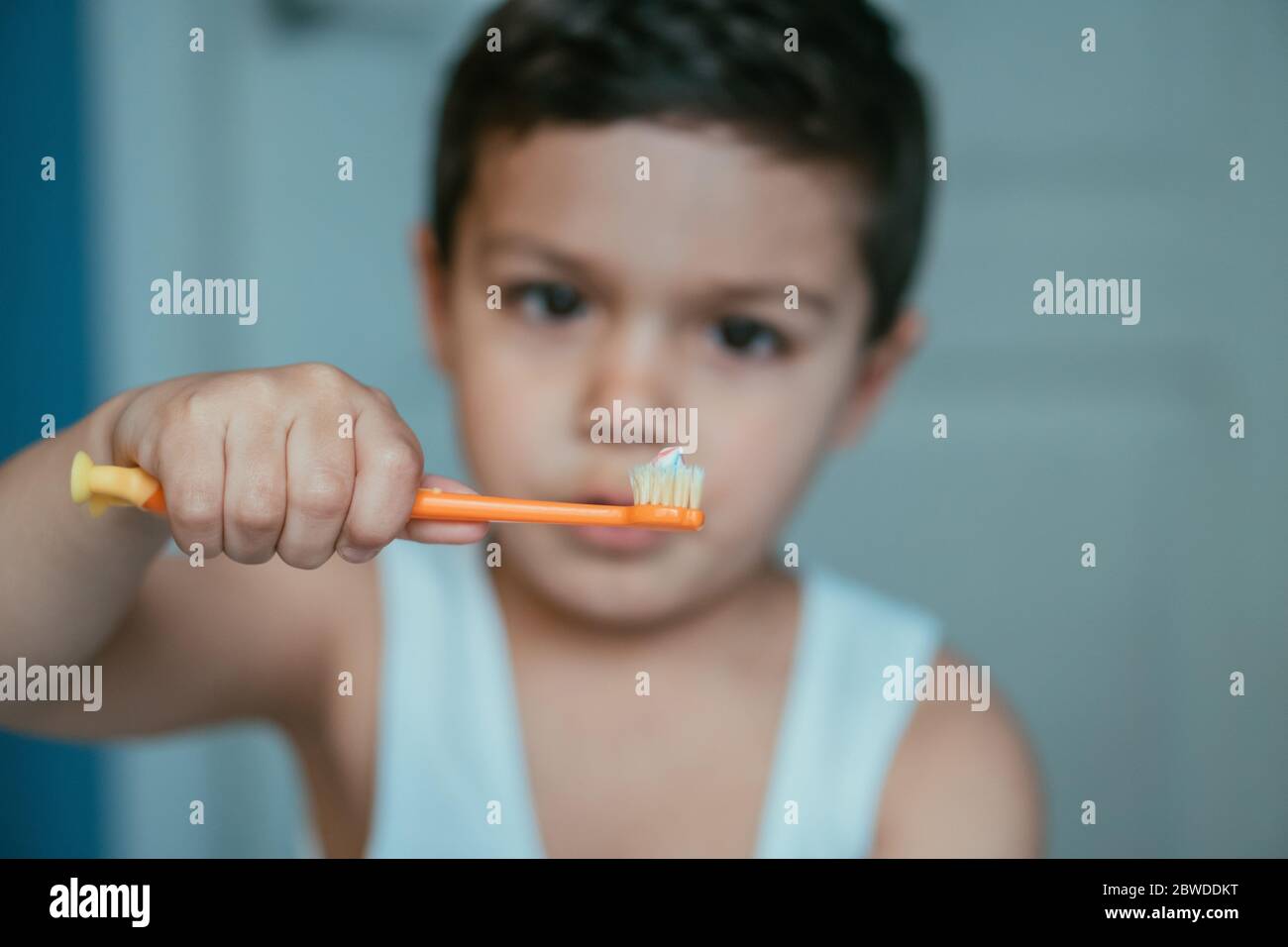 selective focus of cute boy looking at toothbrush with toothpaste Stock ...