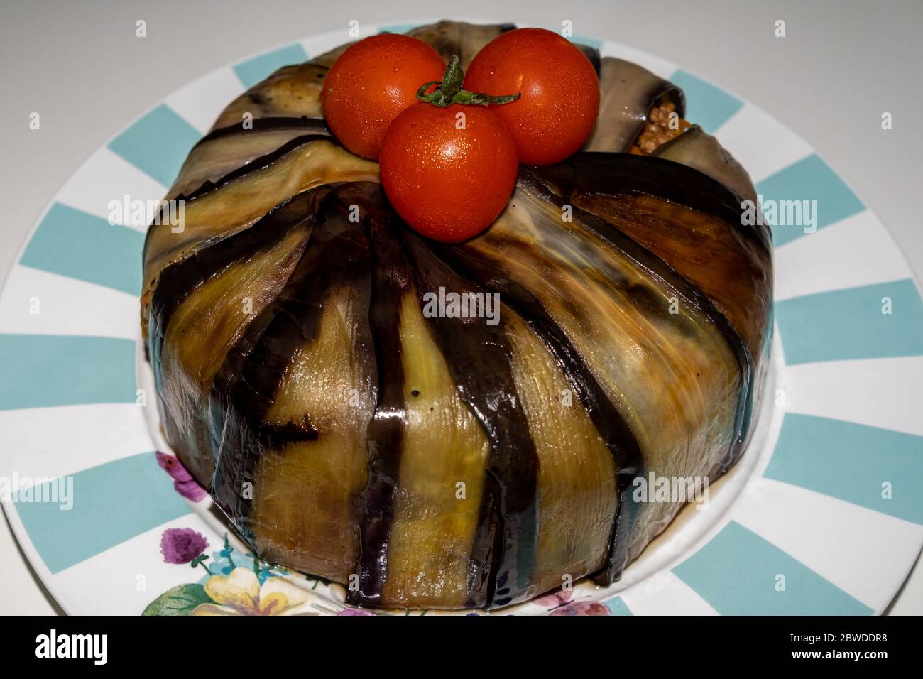 Top view of turkish food with eggplant, tomato and minced meat,ready to ...