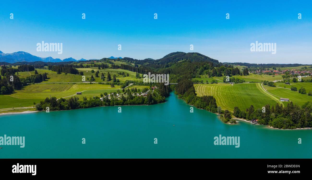 Aerial view over Lake Forggensee at the city of Fuessen in Germany ...