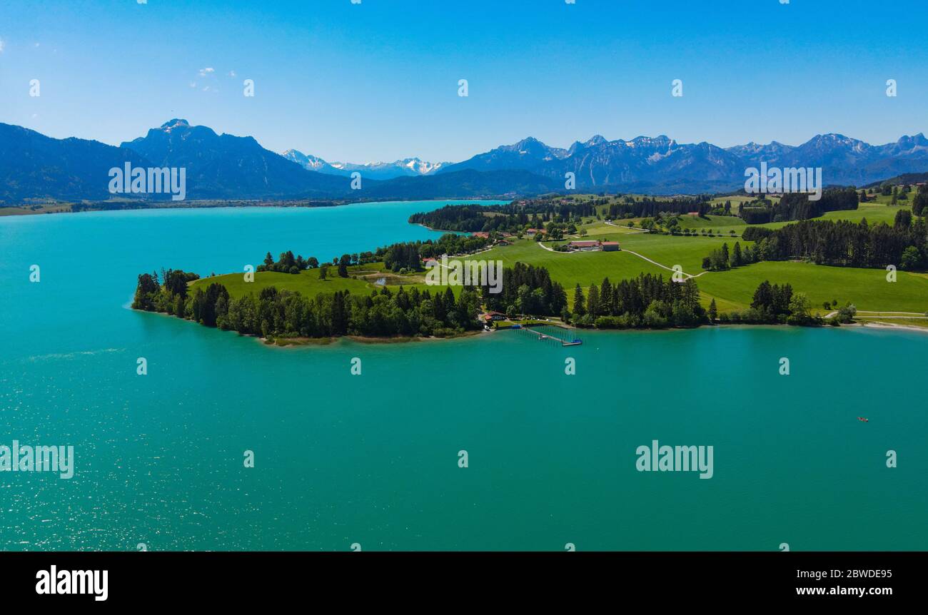 Aerial view over Lake Forggensee at the city of Fuessen in Germany ...