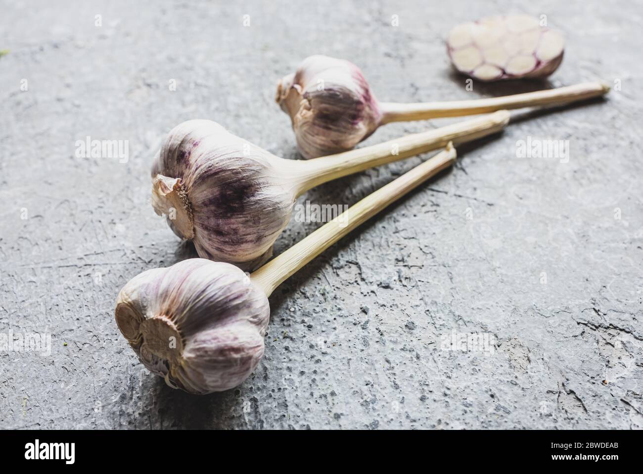selective focus of garlic on grey concrete surface Stock Photo - Alamy
