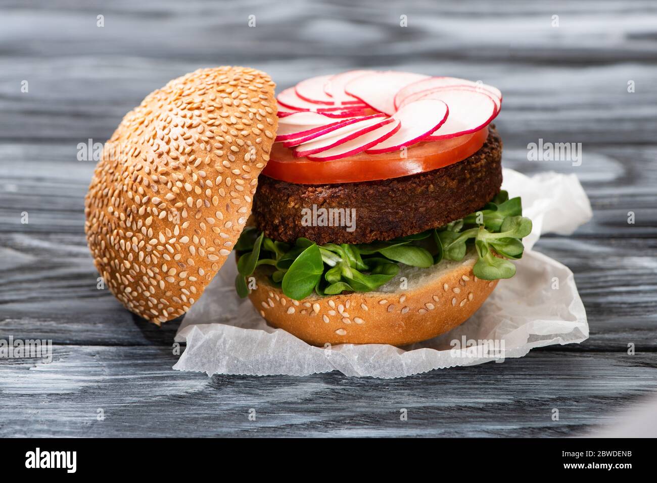 tasty vegan burger with radish served on wooden table Stock Photo - Alamy