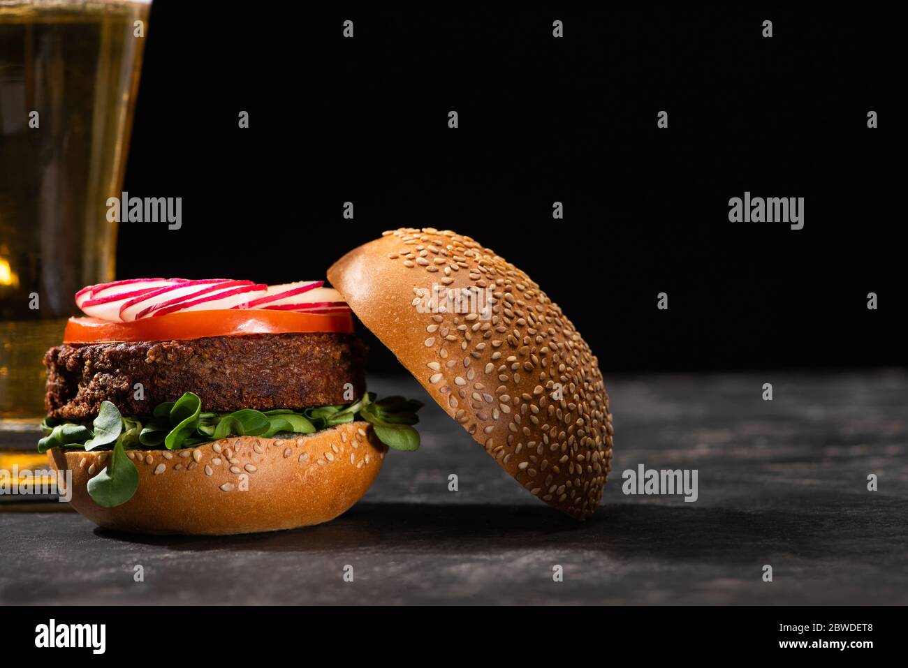 selective focus of tasty vegan burger with microgreens, radish and ...