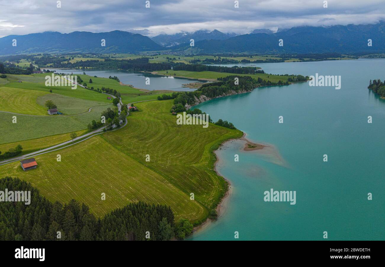 Aerial view over Lake Forggensee at the city of Fuessen in Germany ...