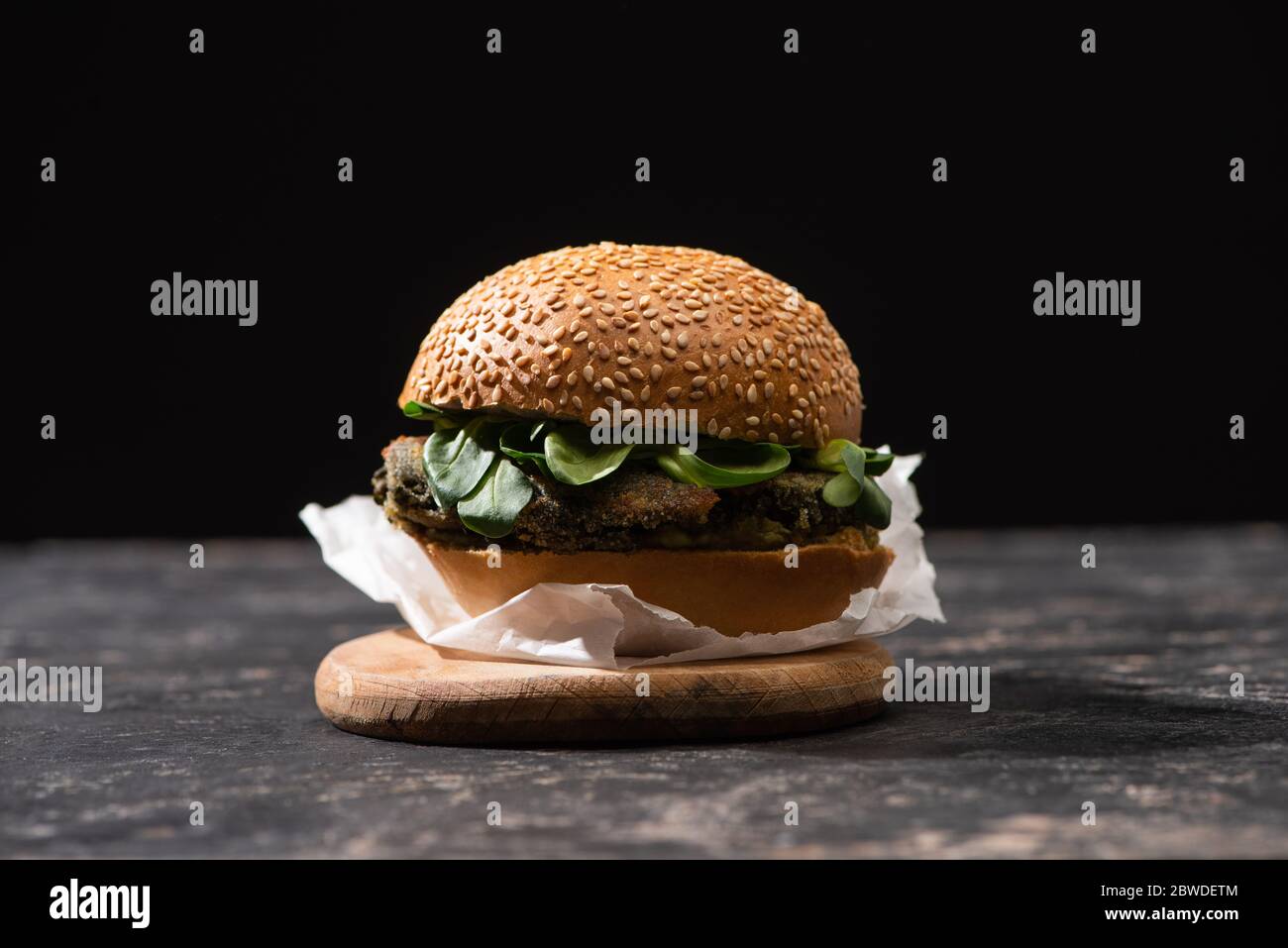 tasty vegan burger with microgreens served on wooden board isolated on ...