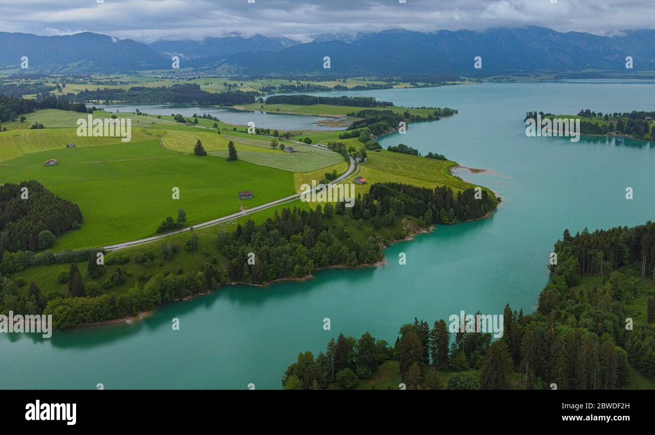 Aerial view over Lake Forggensee at the city of Fuessen in Germany ...