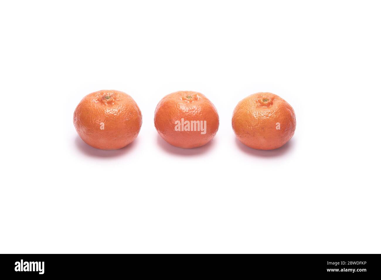 Three mandarins in the center on a white background Stock Photo - Alamy