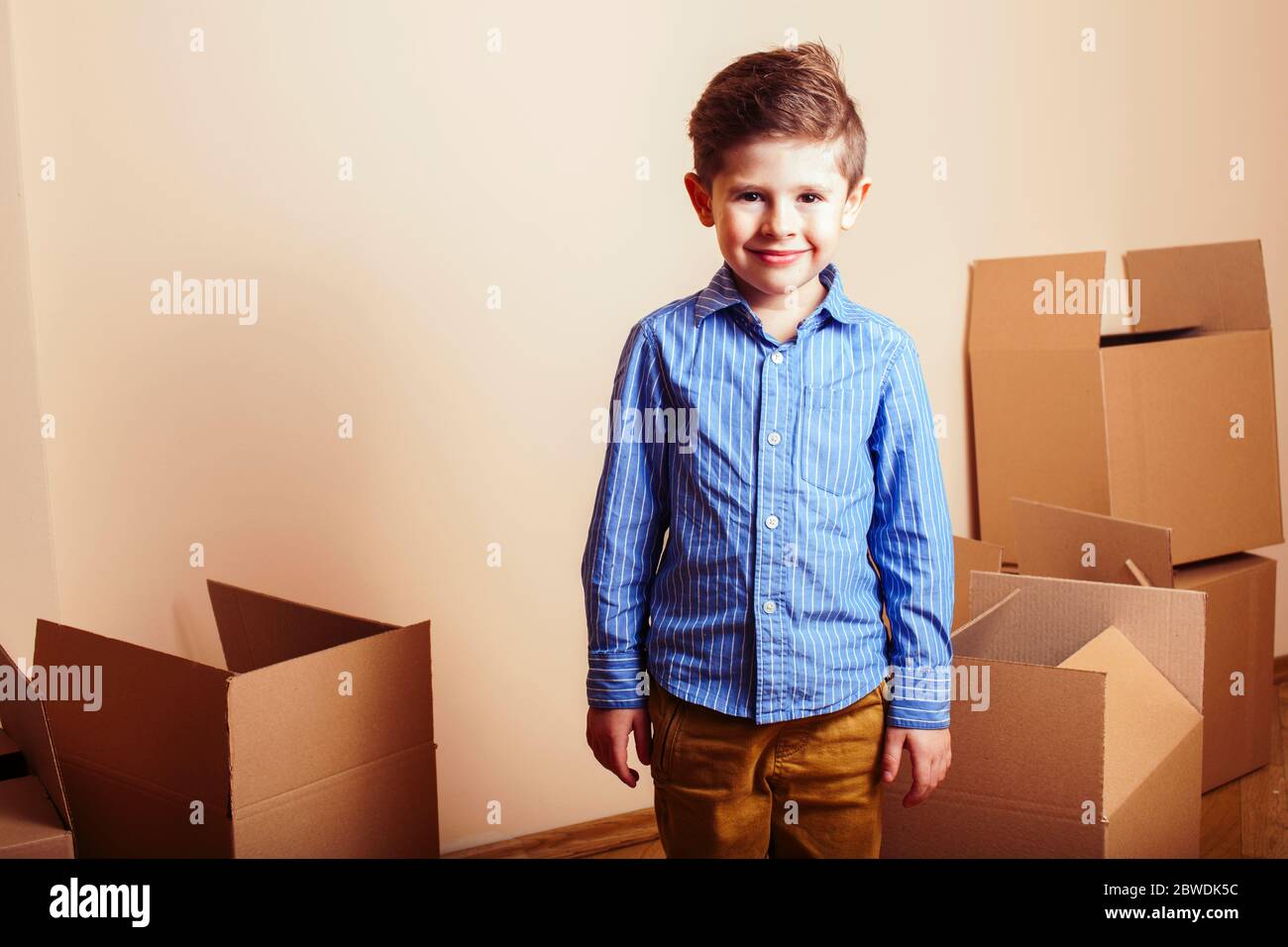 little cute boy in empty room, move to new house. home alone among ...