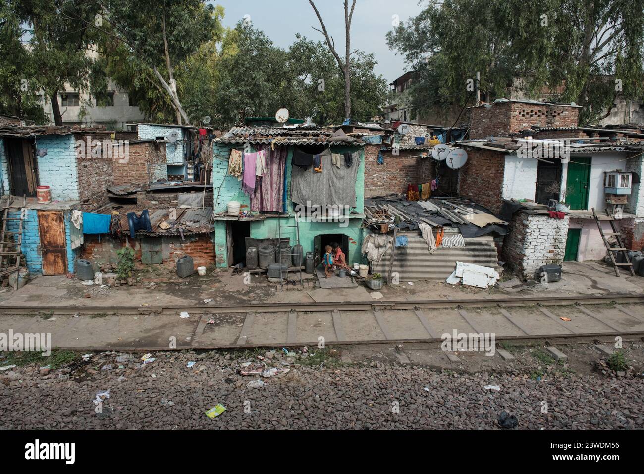 Crowded slums alongside the train tracks. New Delhi, India. India ...