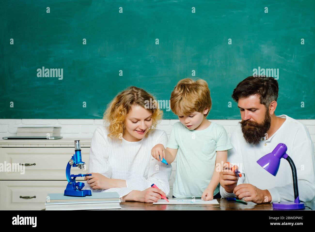 Elementary student. Parents encouraging their little son before the ...