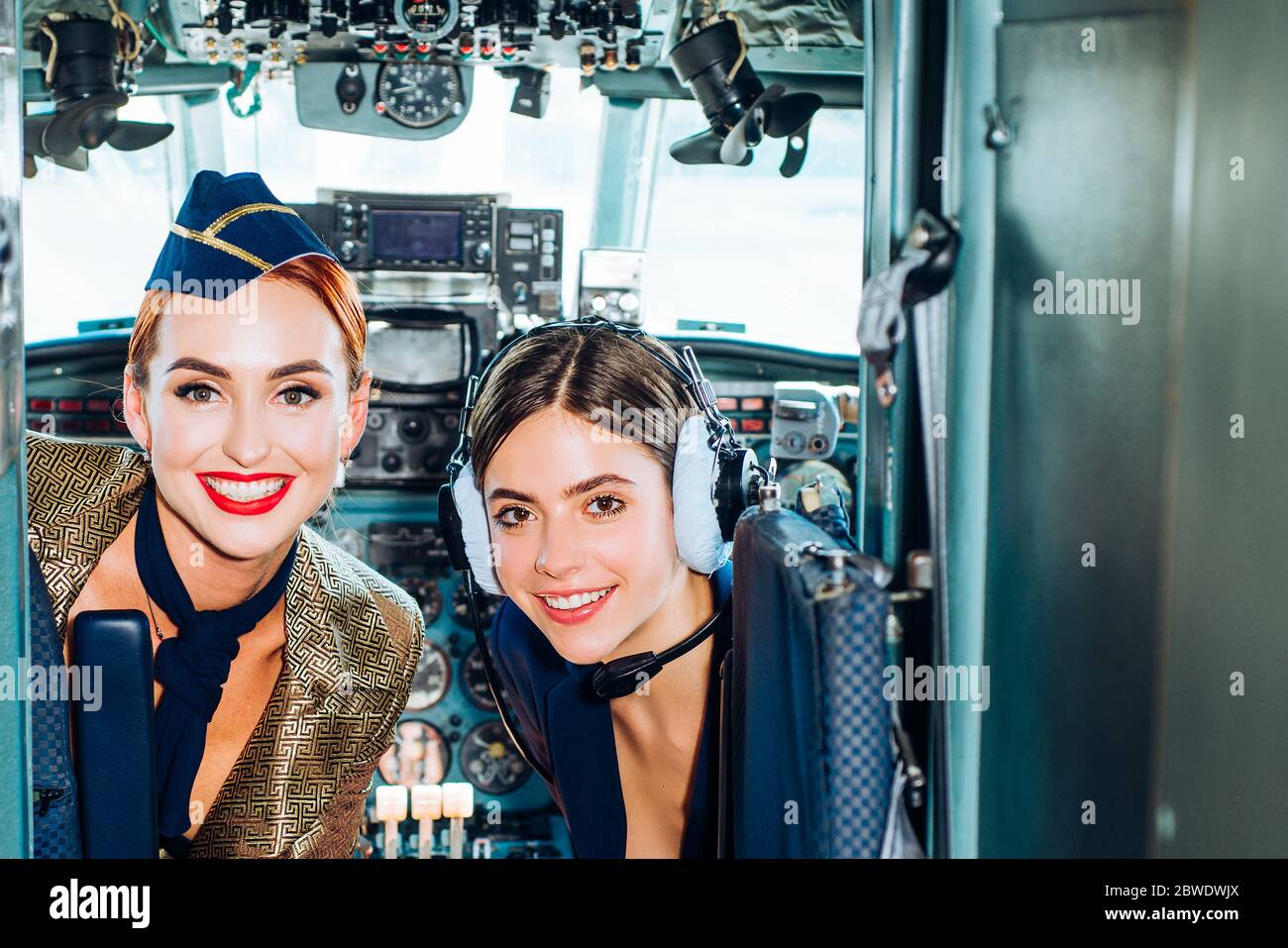 Woman pilot in aviation headsets. Pretty Stewardess. Portrait of ...