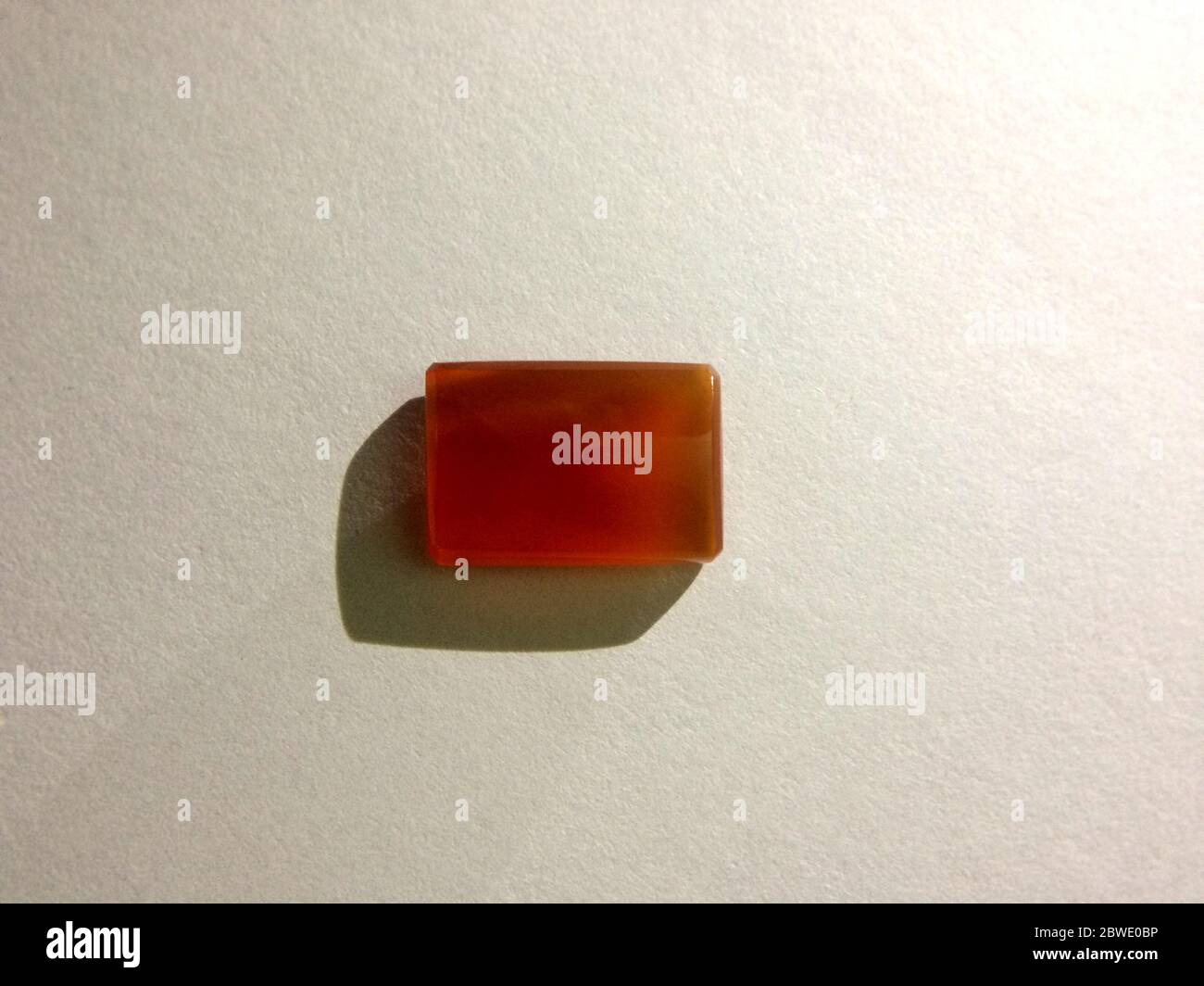 Yemen red aqeeq agate stone on white background. Closeup of natural ...