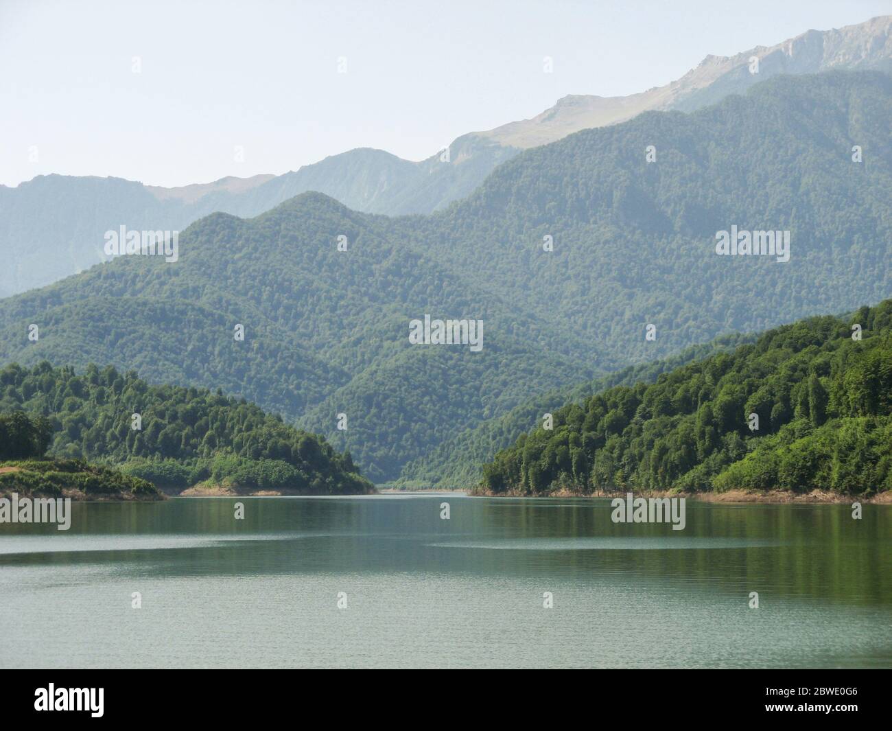 Lake surrounded by mountains and forest in summer day. The forests of ...