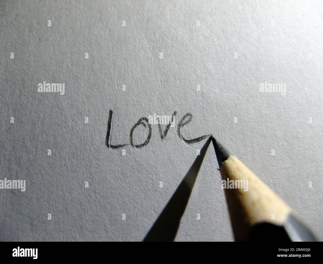 Writing love with pencil on paper Stock Photo - Alamy