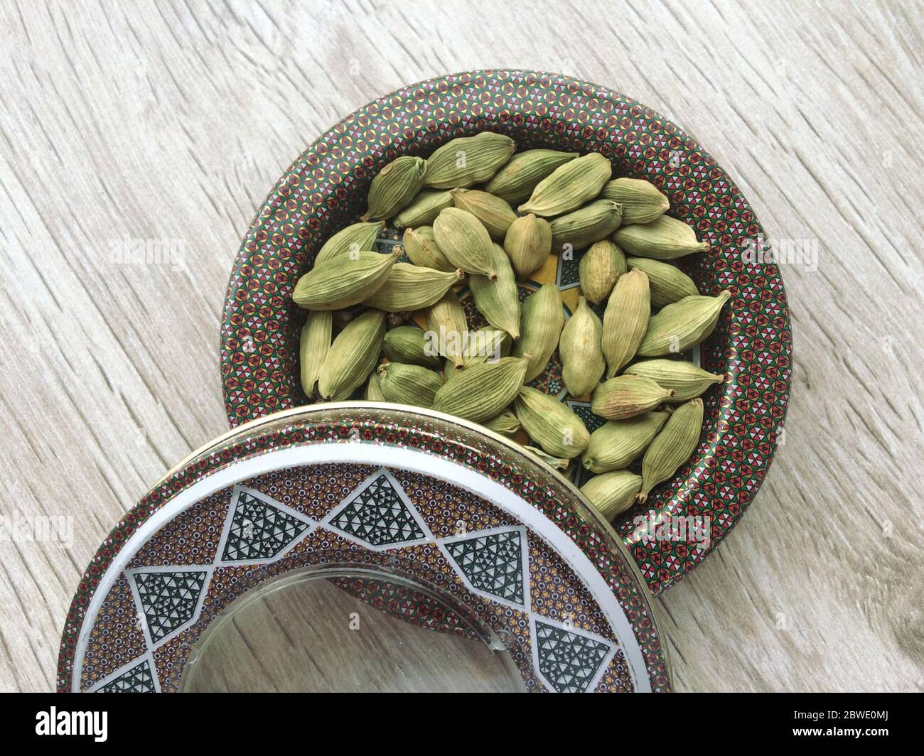 Aromatic cardamom for cooking in kitchen on table background. An ...