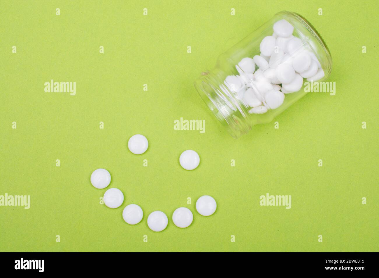 White pill and glass bottle container. Pharmaceutical industry ...