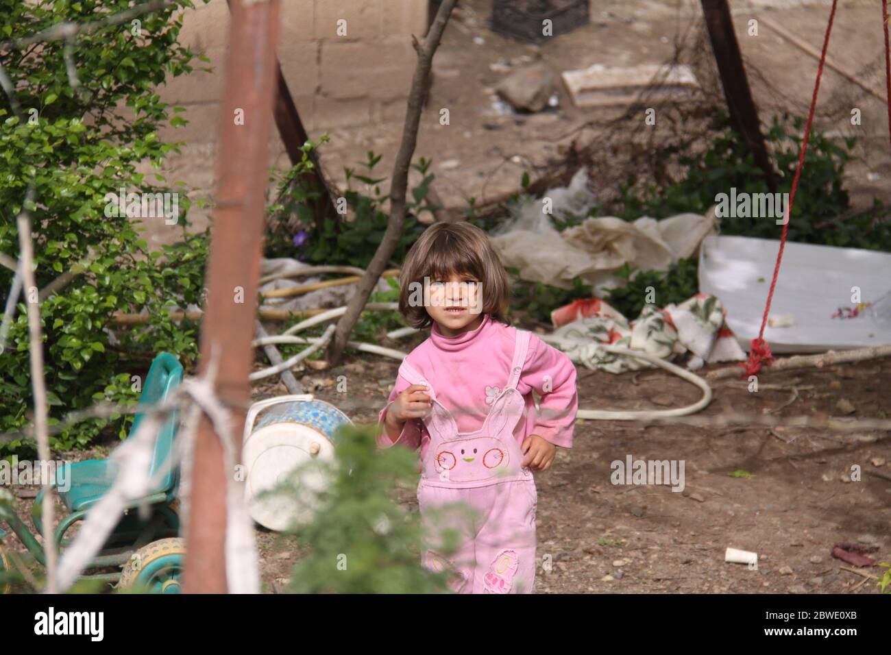A scary little girl outside the city, A swing, different equipment and ...