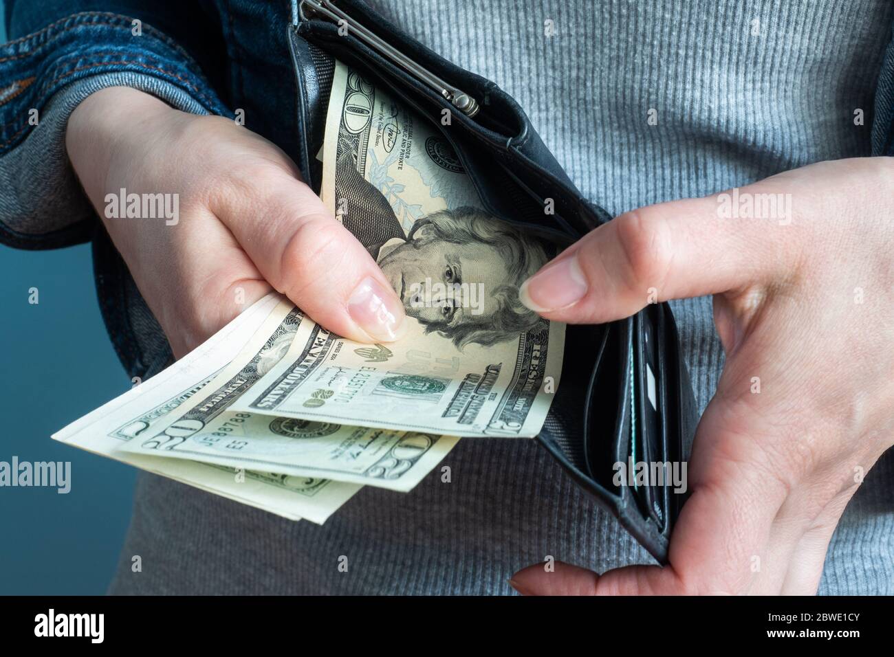 Women's hands take money dollars out of their wallets Stock Photo - Alamy