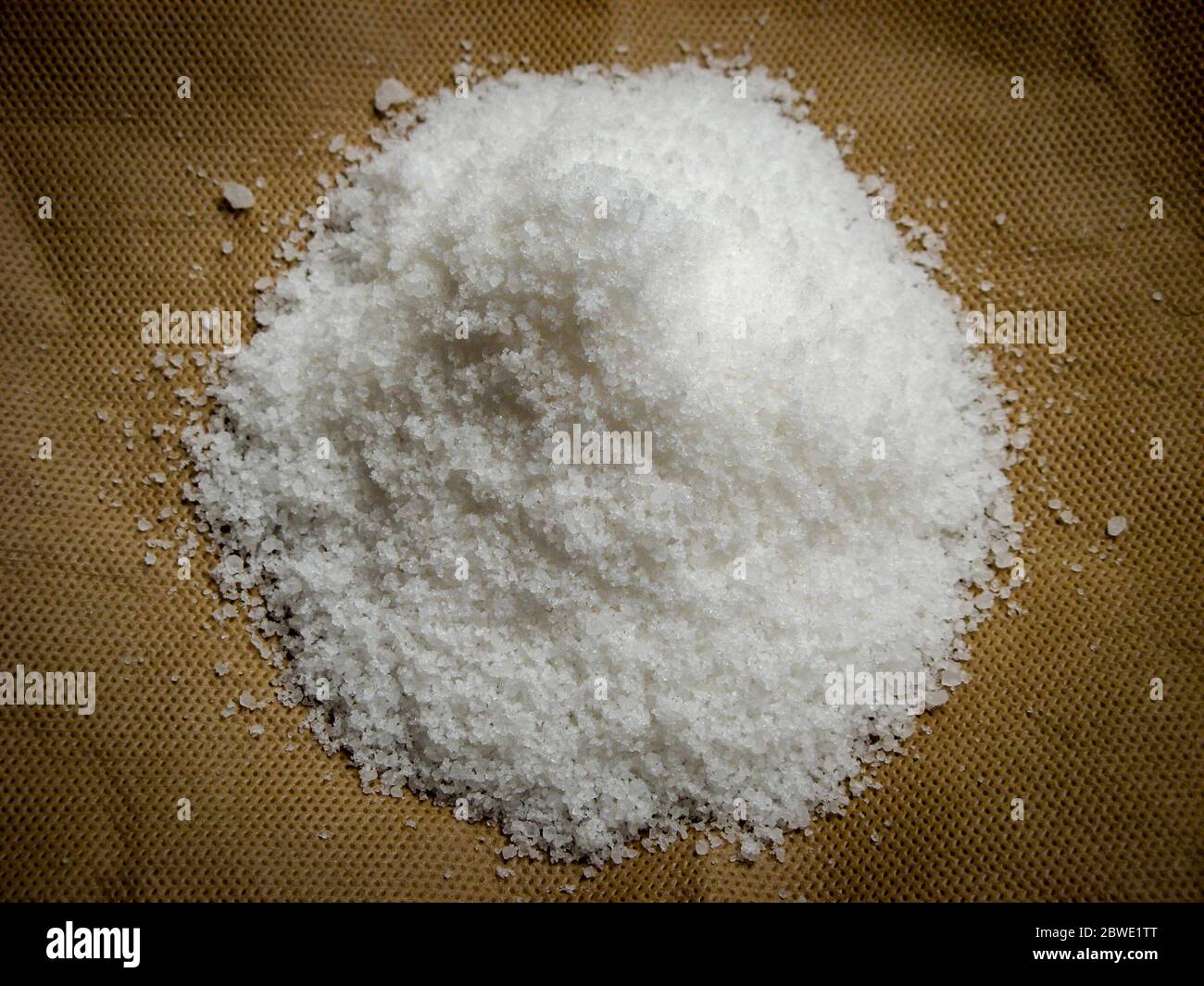 Sea salt on brown background Stock Photo - Alamy