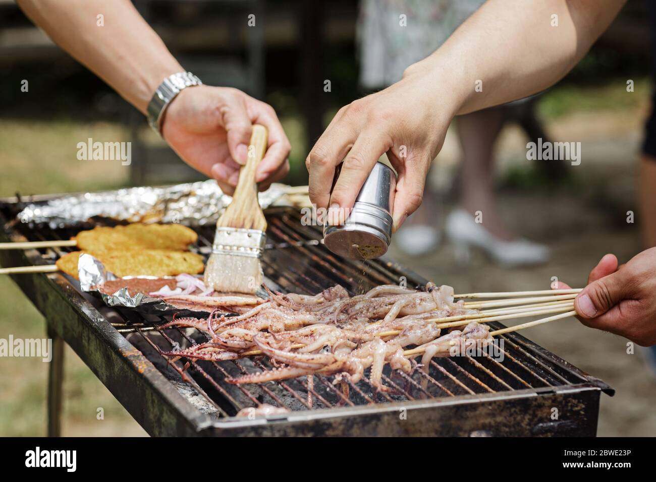 People cooking barbecue outdoor. Summer party with grilled food Stock ...
