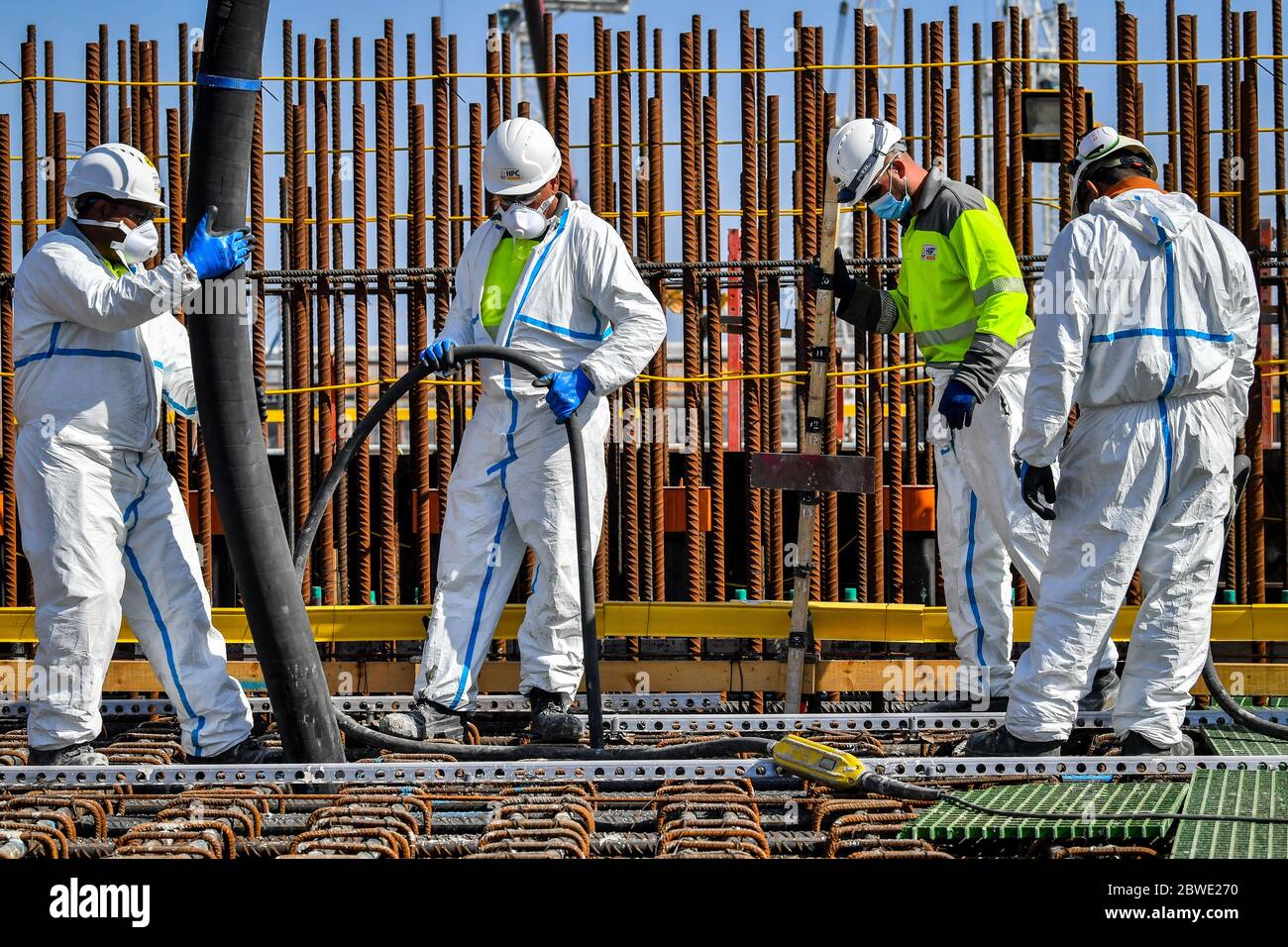 Concrete pouring teams wear extra PPE as they must work closely as a ...