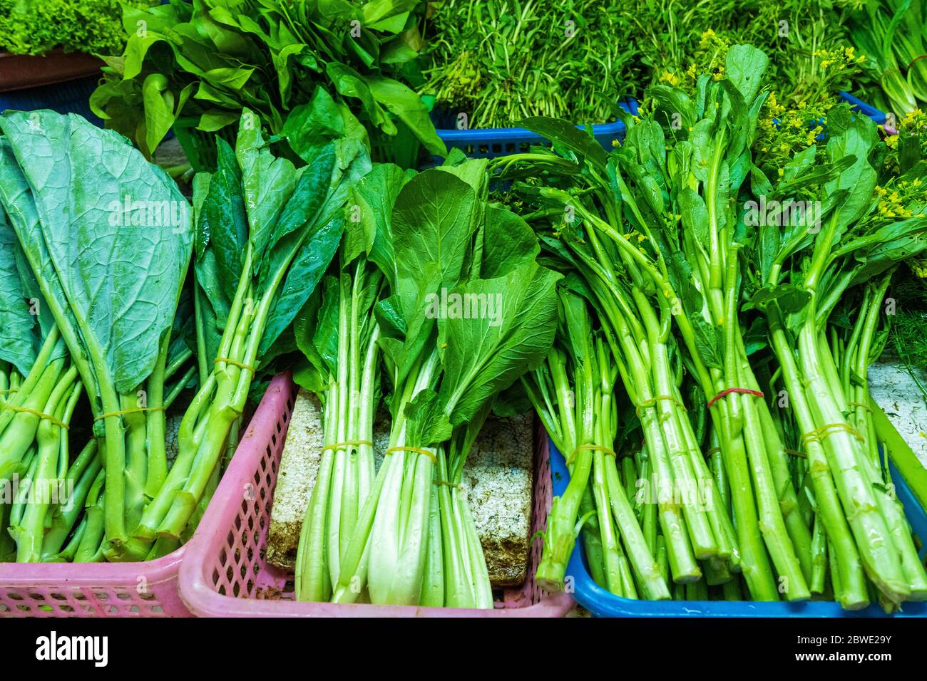 Boxes with greens on a counter at the vegetable market Stock Photo - Alamy
